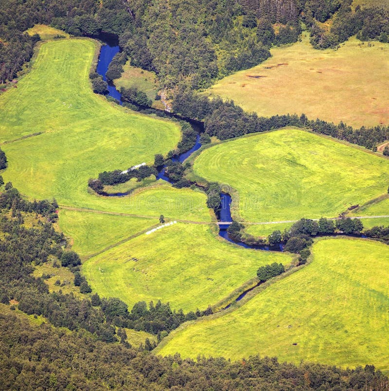 Small River Going through an Area with Green Fields. Stock Image ...