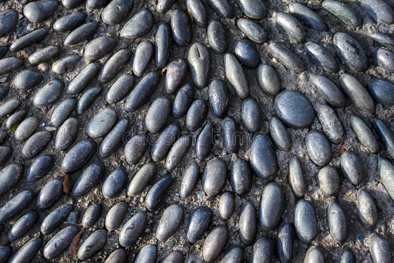 Small River Rocks Set in Concrete in a Abstract Pattern, As Graphic ...