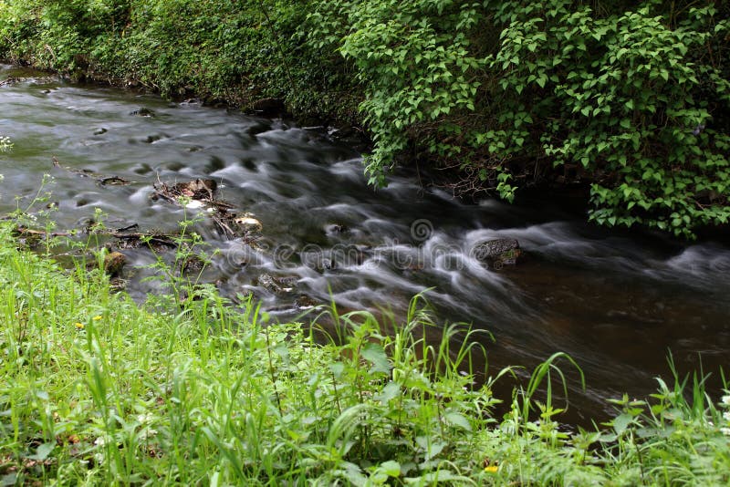 A small river with stones stock photo. Image of exposure - 181922262