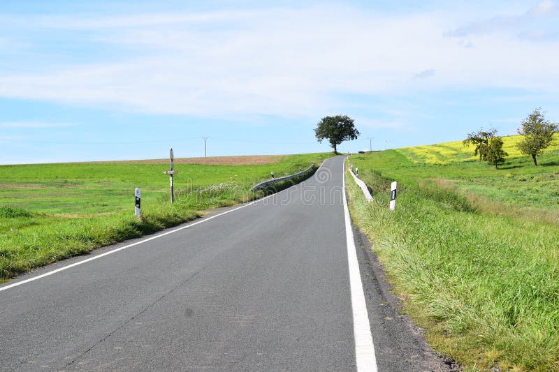 Small Road Up a Hill with a Single Tree Stock Photo - Image of rural ...