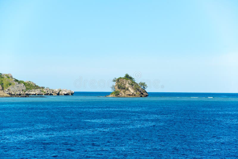 Small Rock Overgrown with Plants in the Ocean Stock Photo - Image of ...