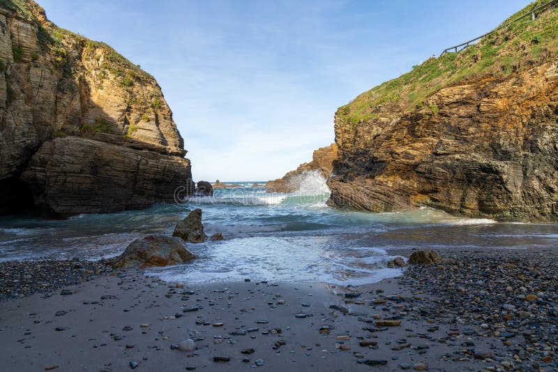 Small Rock and Sand Beach in a Sheltered Cove with Cliffs on the Side ...