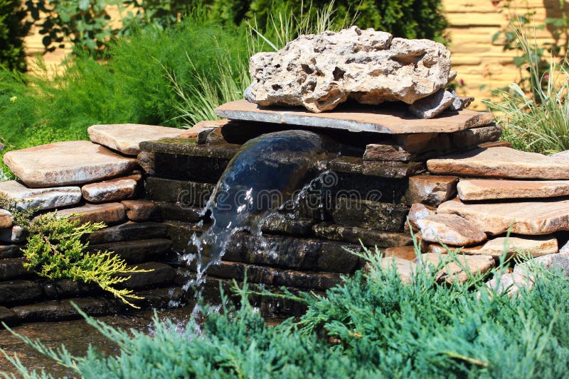 Small Rockery with Waterfall in a Garden Stock Image - Image of ...