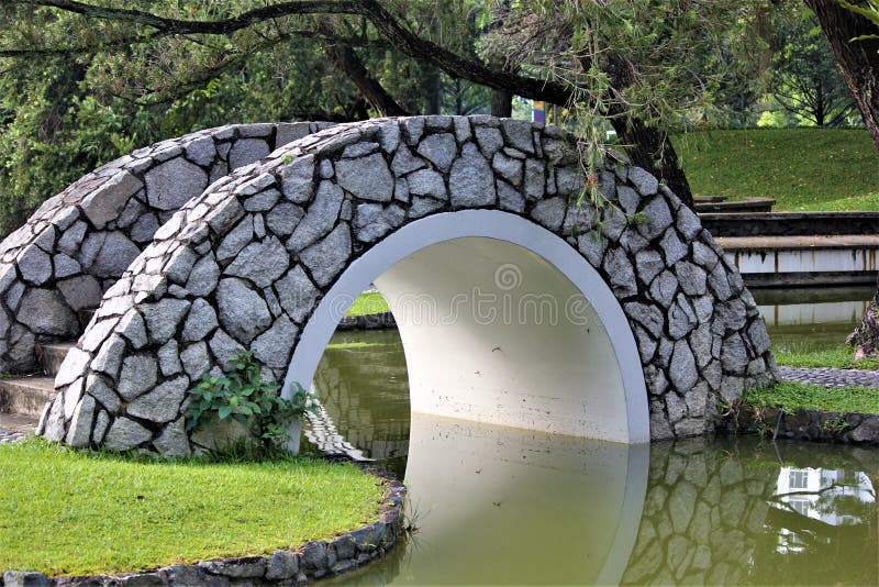 A Small Rocky Bridge Over a Pond Stock Image - Image of colour, park ...