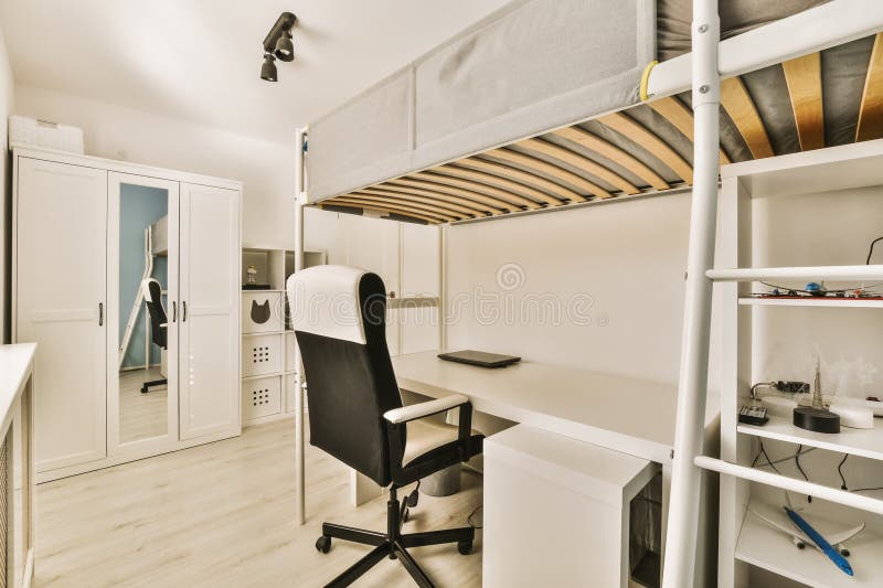 A Small Room with a Bunk Bed and a Desk Stock Image - Image of storage ...