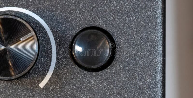 Small Round Blank Empty Black Button Next To Metallic Knob on Textured ...