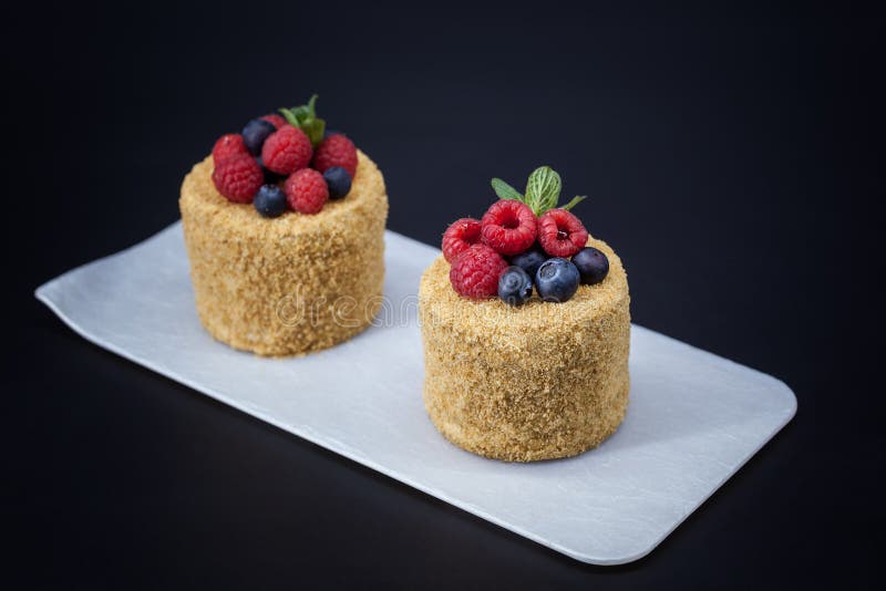 Small Round Cakes with Berries on a Black Background Stock Photo ...