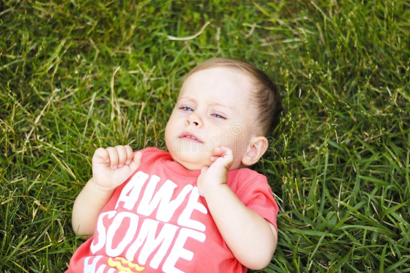 Small sad boy on grass stock image. Image of small, emotion - 41661883