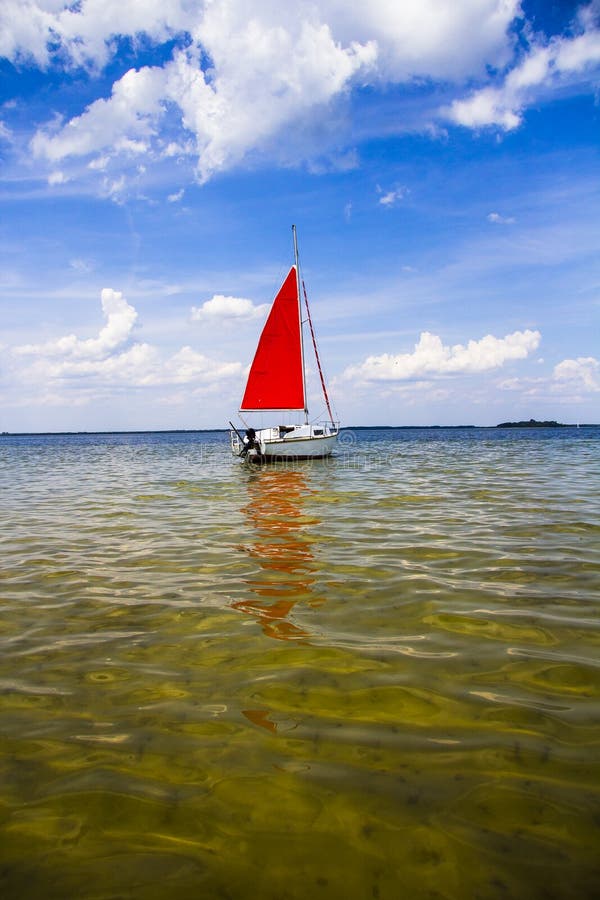 Small Sailboat with a Red Sail on the Lake Stock Photo - Image of ...