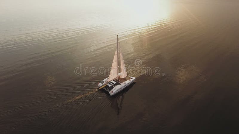 A Small Sailing Yacht Sails on the River at Sunset Stock Footage ...