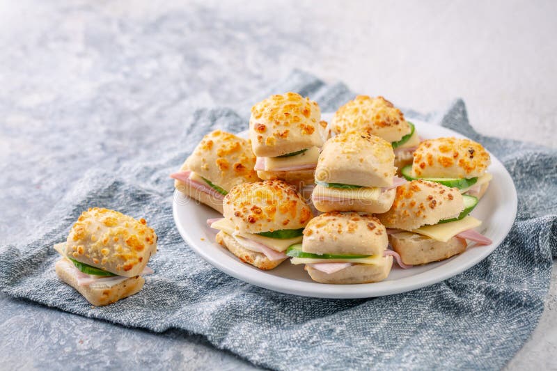 Small Sandwiches with Ham and Cheese As Appetizers on a Plate Stock ...