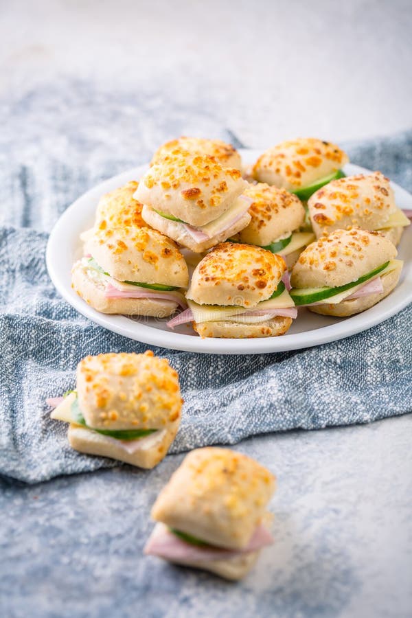 Small Sandwiches with Ham and Cheese As Appetizers on a Plate Stock ...