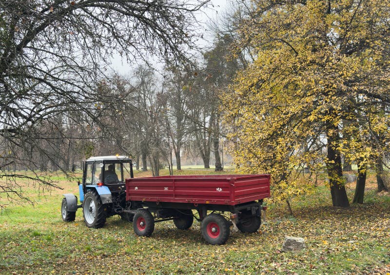 Small Scale Farming with Tractor and Plow in Field. Stock Photo - Image ...