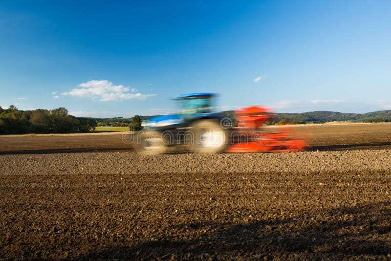 Tractor in plowed field stock photo. Image of cultivate - 98879606