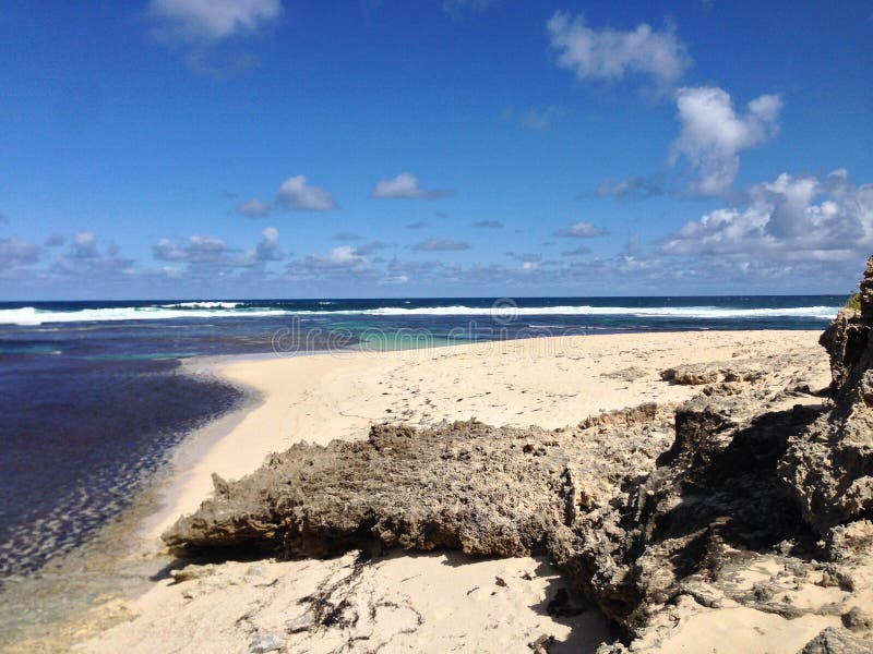 Rocks and Beach with Calm Ocean and Blue Sky Stock Image - Image of ...