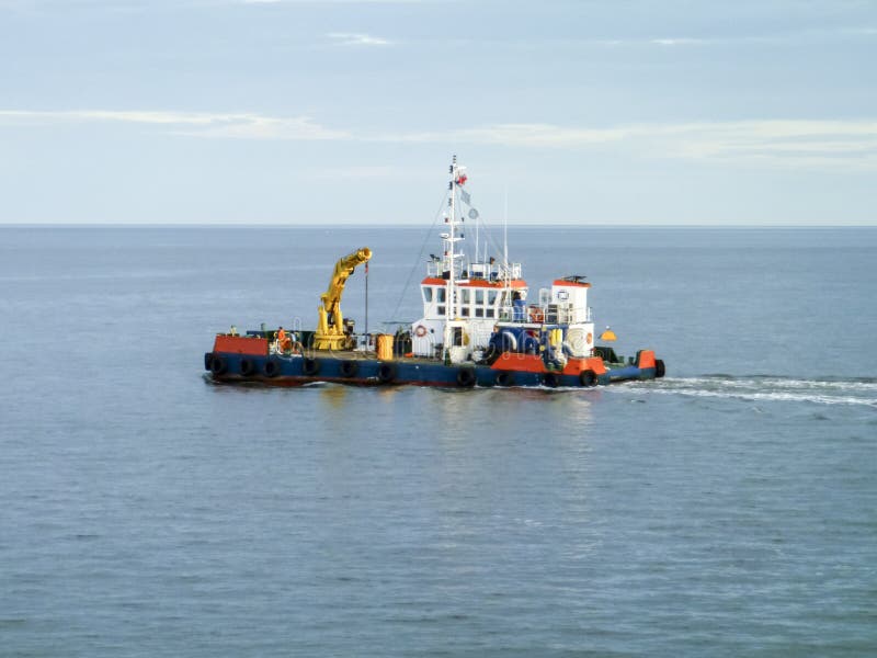 A Small Service Ship in a Cargo Industrial Port. a Ship in the Sea ...