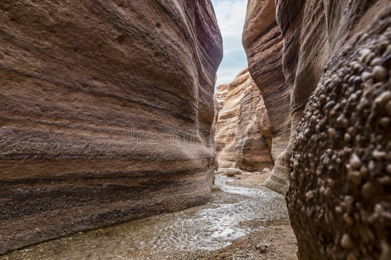 A Small Shallow Stream Flows between High Rocks with Beautiful Natural ...