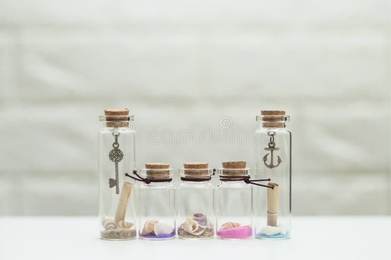 Small Shells in a Small Glass Bottle Stock Photo - Image of bottles ...