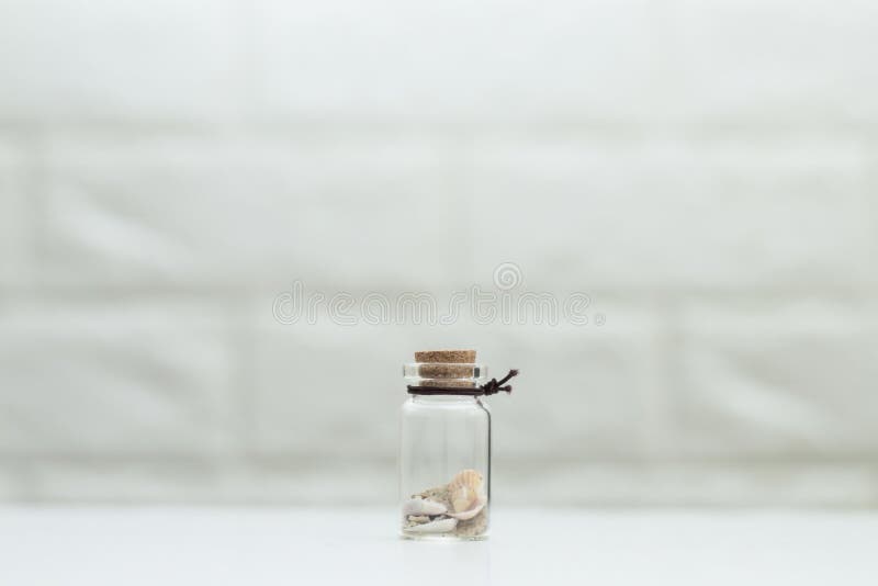 Small Shells in a Small Glass Bottle Stock Photo - Image of green, luck ...