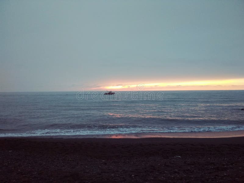 A Small Ship in a Calm Sea at Sunset Stock Photo - Image of sunset ...