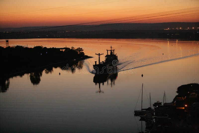 A Small Ship Crousing during a Sunset Stock Photo - Image of dawn ...
