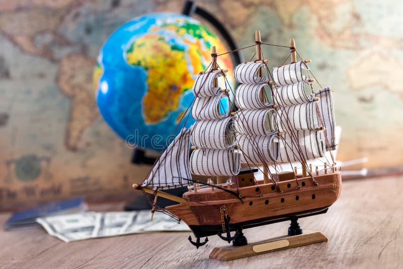 Small Ship with Globe and Map Dollar on Desk Stock Photo - Image of ...