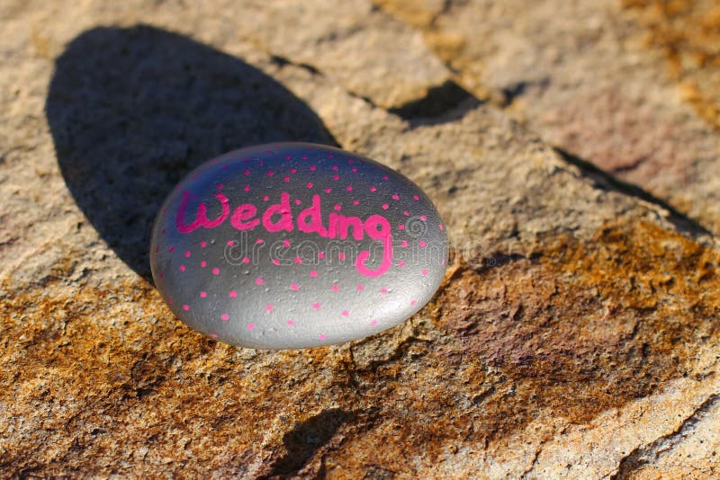Small Silver Rock with Pink Painted Word & X22;Wedding& X22; Stock ...