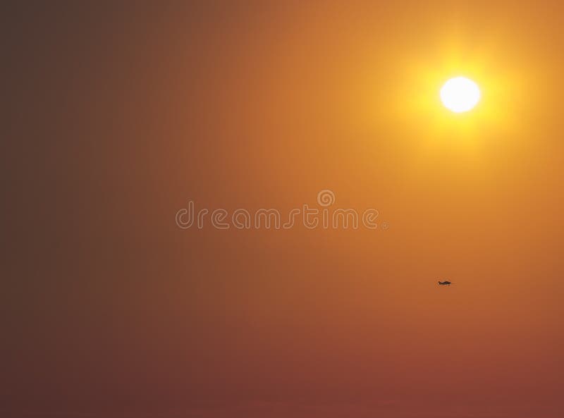 A Small Single-engine Aircraft Against the Backdrop of a Bright Sunset ...