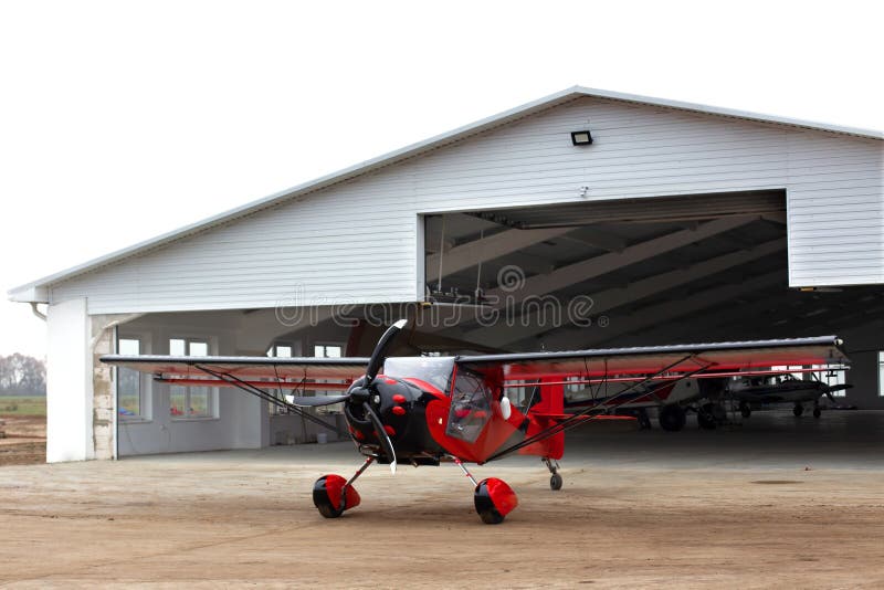 Small Single Prop Engine Plane Parked in Front of Workshop Hangar ...