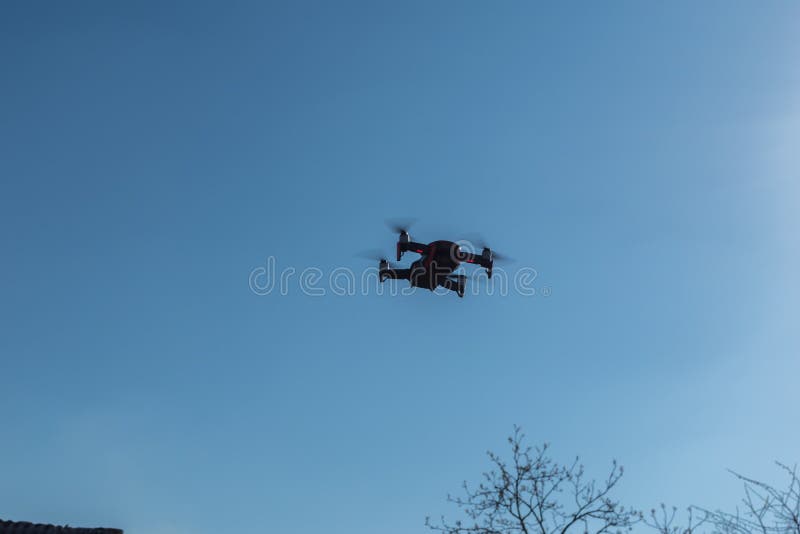 Small Sized Red Drone with High Resolution Camera Hovering in Air for ...