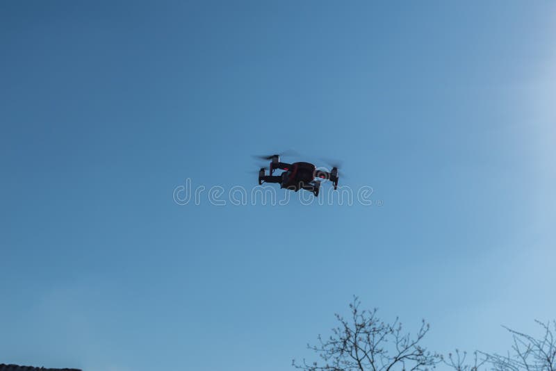 Small Sized Red Drone with High Resolution Camera Hovering in Air for ...