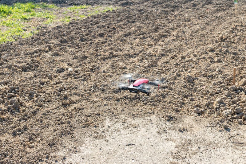 Small Sized Red Drone with High Resolution Camera Hovering in Air for ...