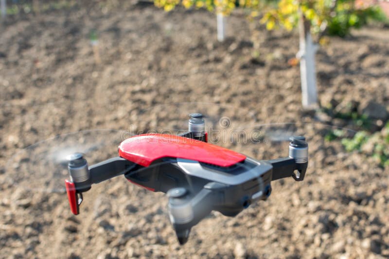 Small Sized Red Drone with High Resolution Camera Hovering in Air for ...