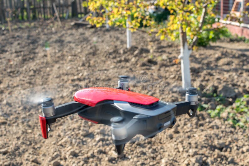 Small Sized Red Drone with High Resolution Camera Hovering in Air for ...