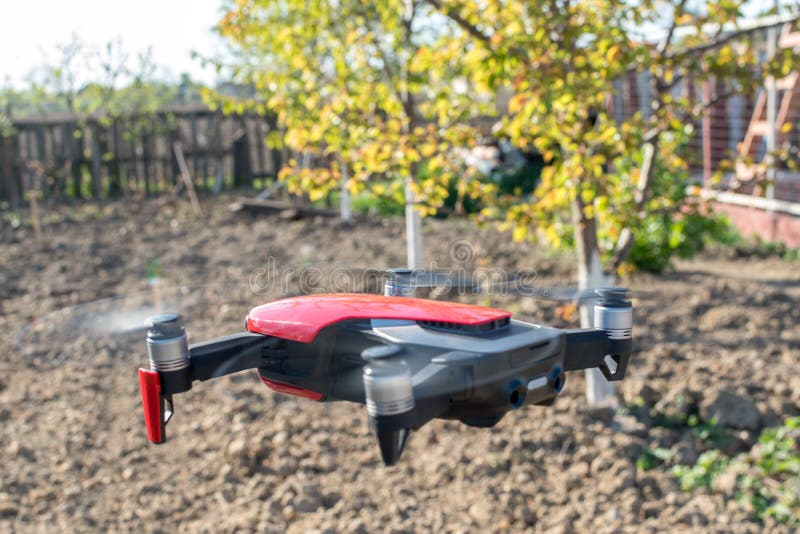 Small Sized Red Drone with High Resolution Camera Hovering in Air for ...