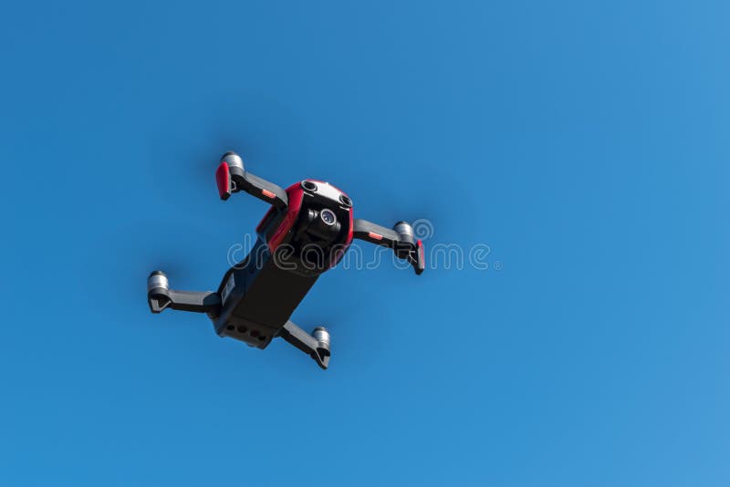 Small Sized Red Drone with High Resolution Camera Hovering in Air for ...