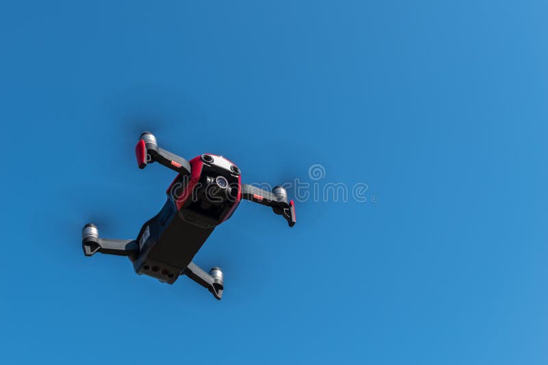 Small Sized Red Drone with High Resolution Camera Hovering in Air for ...