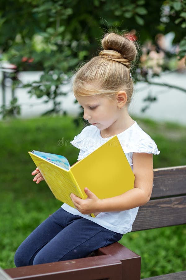 A Small Smart Child is Reading an Interesting Book. the Concept is Back ...