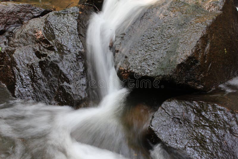 A Small Soft Waterfall Covering the Rocks Stock Image - Image of soft ...
