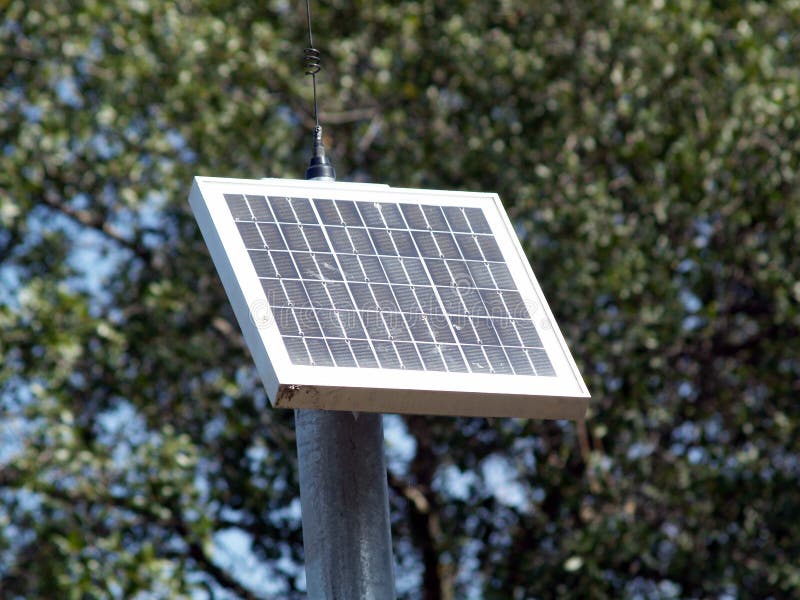 Small Solar Panel on Pole with Trees Stock Image - Image of small ...