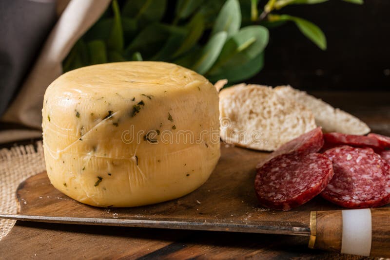 A Small Spiced Cheese Piece on a Board with Bread and Salami Stock ...