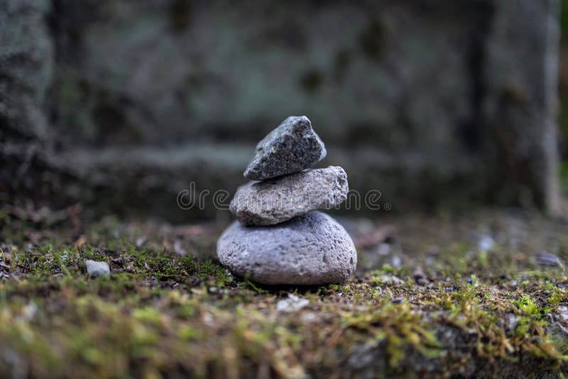 Small Stack of Three Balanced Stones on a Moss-covered Surface Captured ...