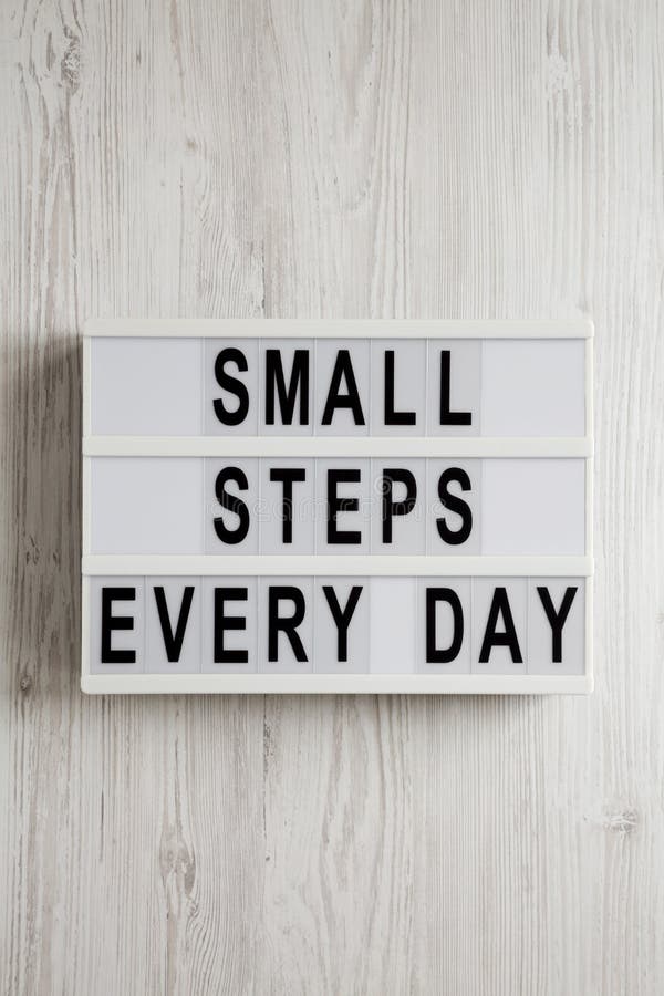 `Small Steps Every Day` Words on a Lightbox on a White Wooden Surface ...