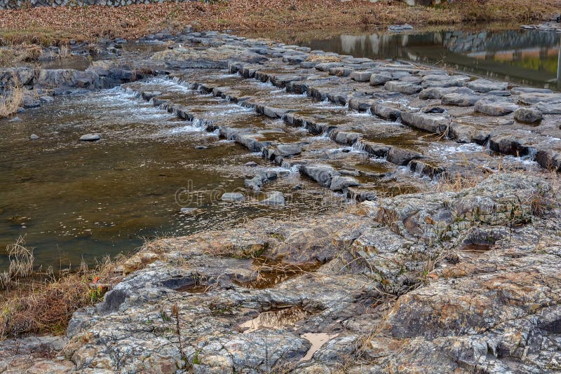 Small stone dam on stream. stock image. Image of nature - 129167757