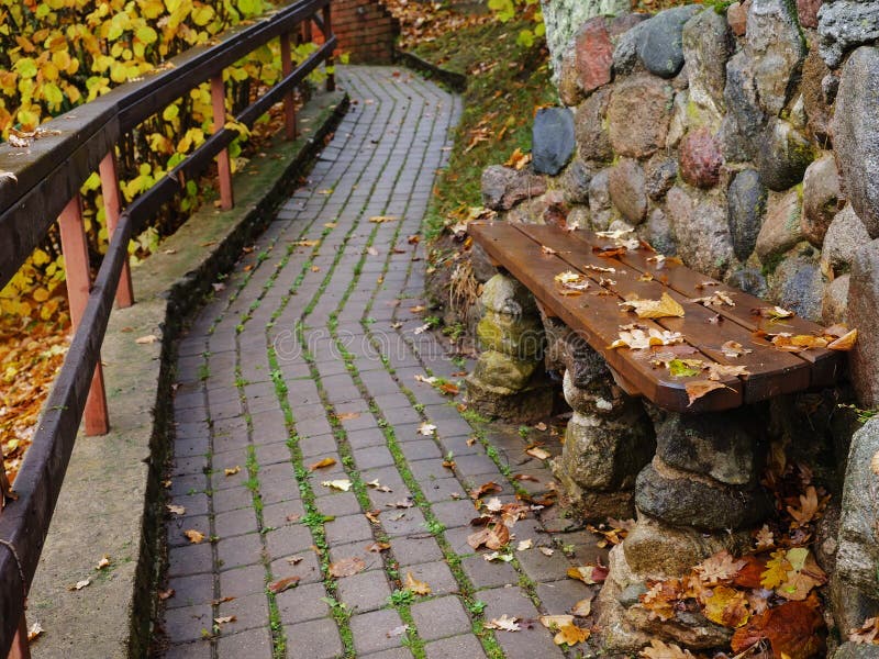 Small Stone Path in a Park and a Bench Made with Stone Covered with ...