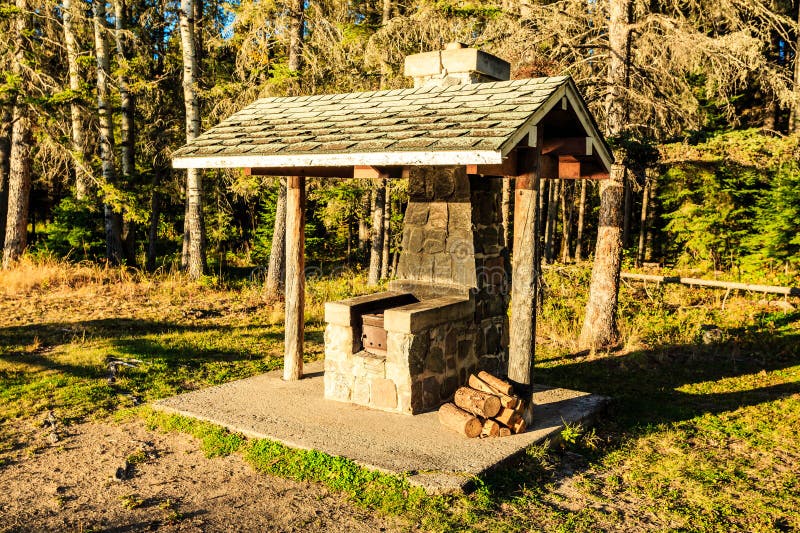 A Small Stone Structure with a Chimney and a Fire Pit Stock Photo ...