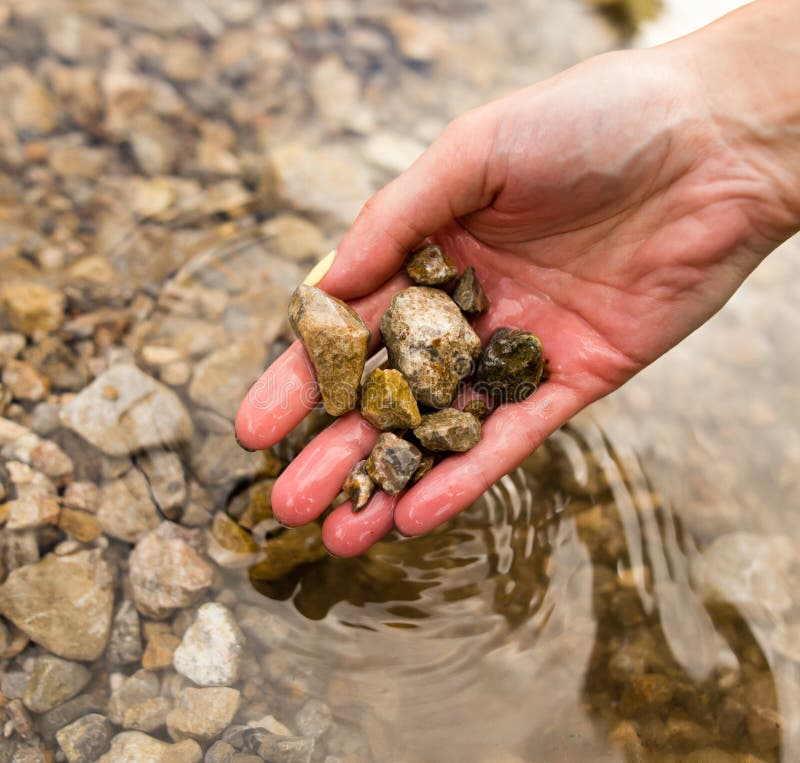 Small Stones in the Hand on the Pond Stock Image - Image of outdoor ...