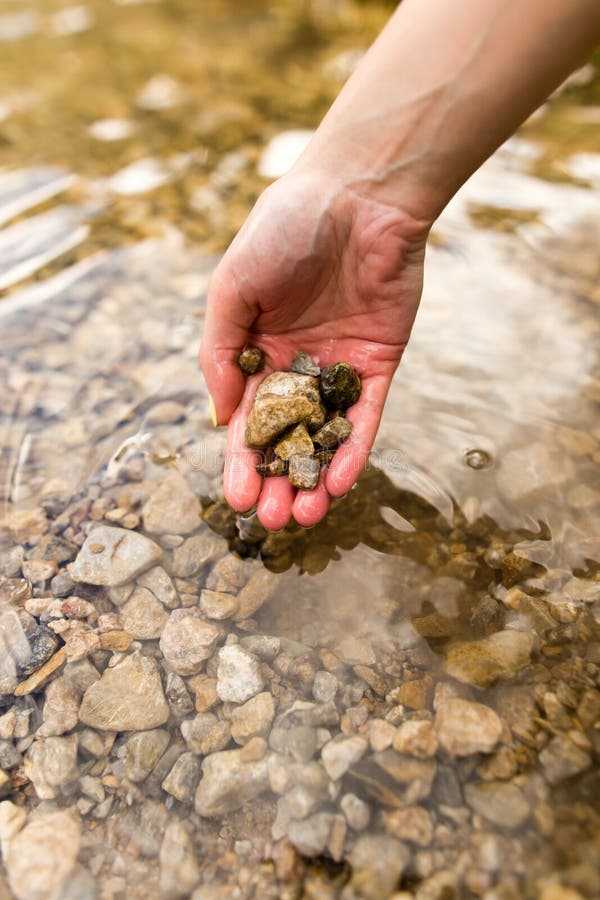 Small Stones in the Hand on the Pond Stock Photo - Image of abstract ...