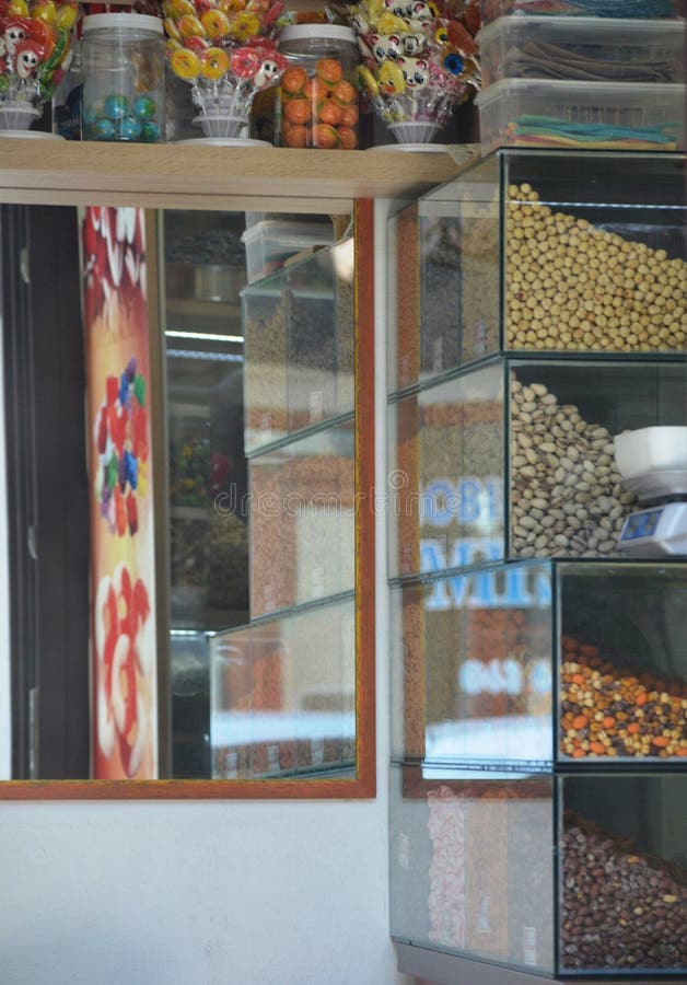A Small Store with a Glass Front and a Few People Standing Outside ...
