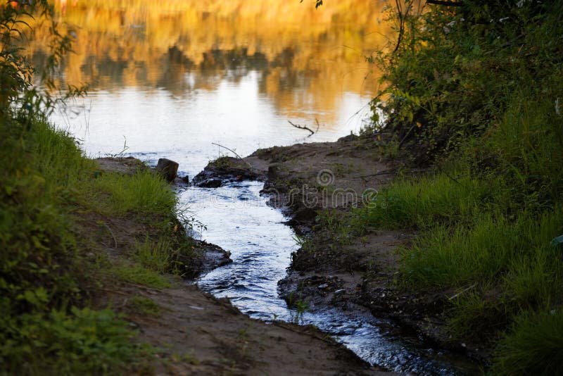 A Small Stream Flows Out of a Large Lake Stock Photo - Image of flowing ...